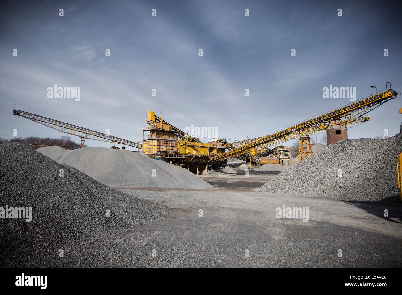 Quarry machines in a landscape of artificial hills of ground and rocks ...