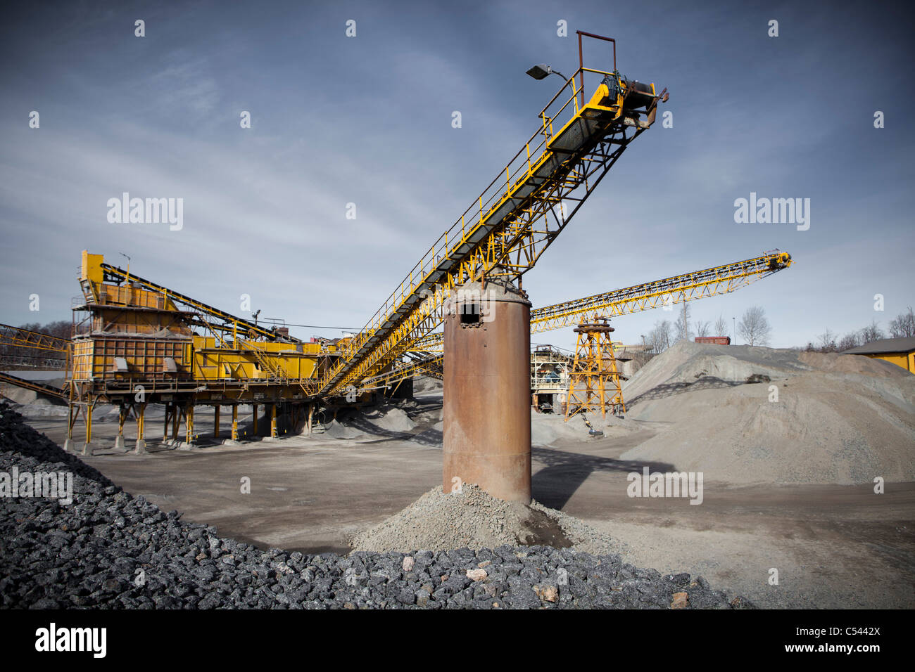 Quarry machines in a landscape of artificial hills of ground and rocks ...