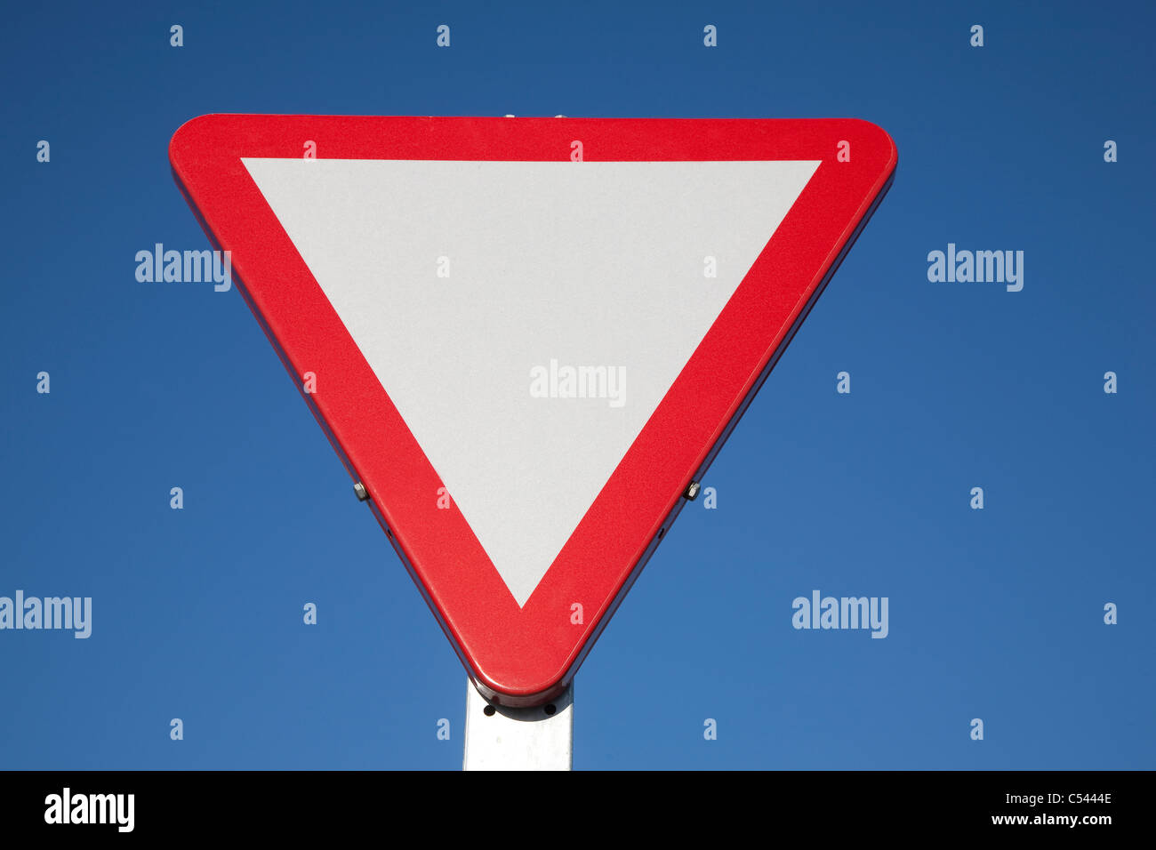Blank Give Way Sign against Blue Sky Background Stock Photo - Alamy