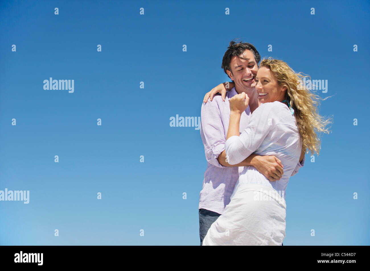 Couple embracing each other and smiling Stock Photo - Alamy