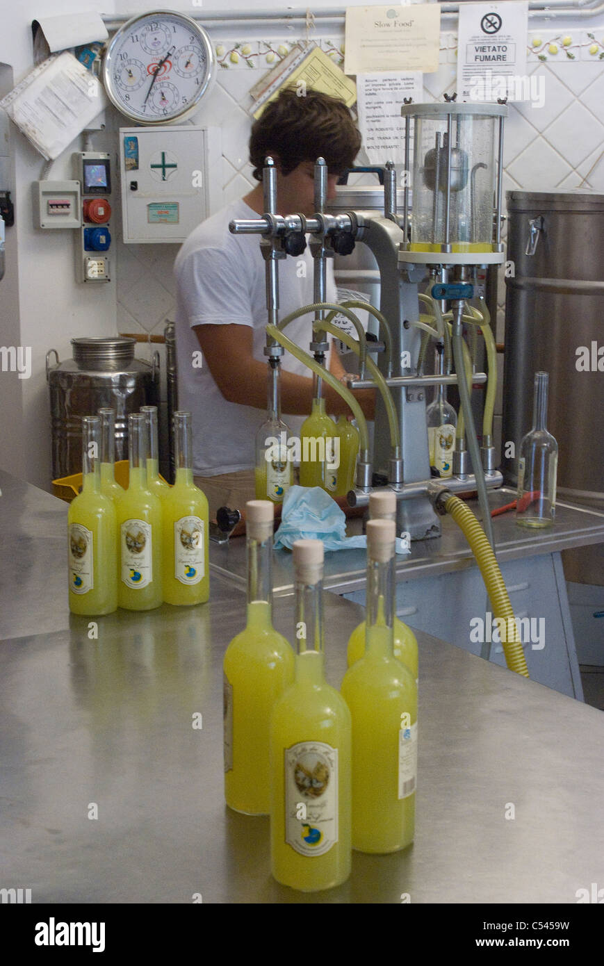 Bottling locally produced limoncello liqueur, made from lemons grown in ...