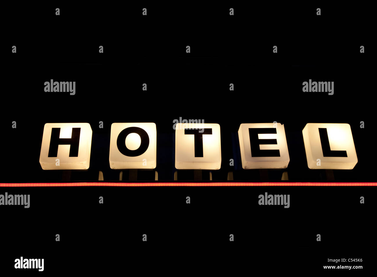 Illuminated Hotel Sign against Black Background Stock Photo - Alamy