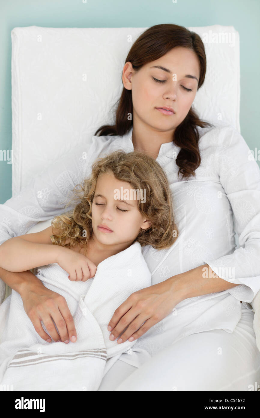 Young woman sleeping with little girl wrapped in towel Stock Photo - Alamy