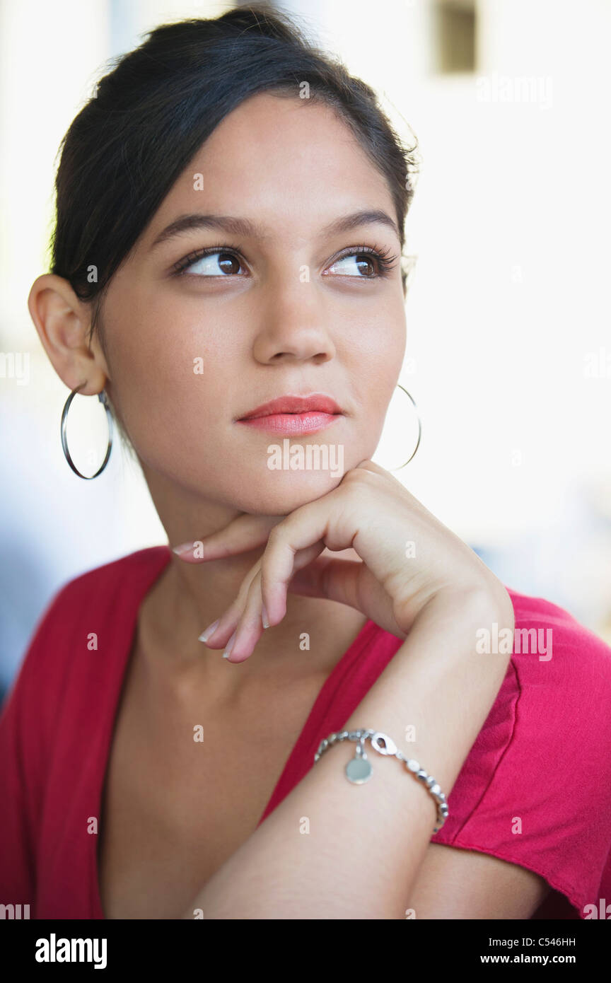 Contemplative woman looking away with hand on chin Stock Photo - Alamy