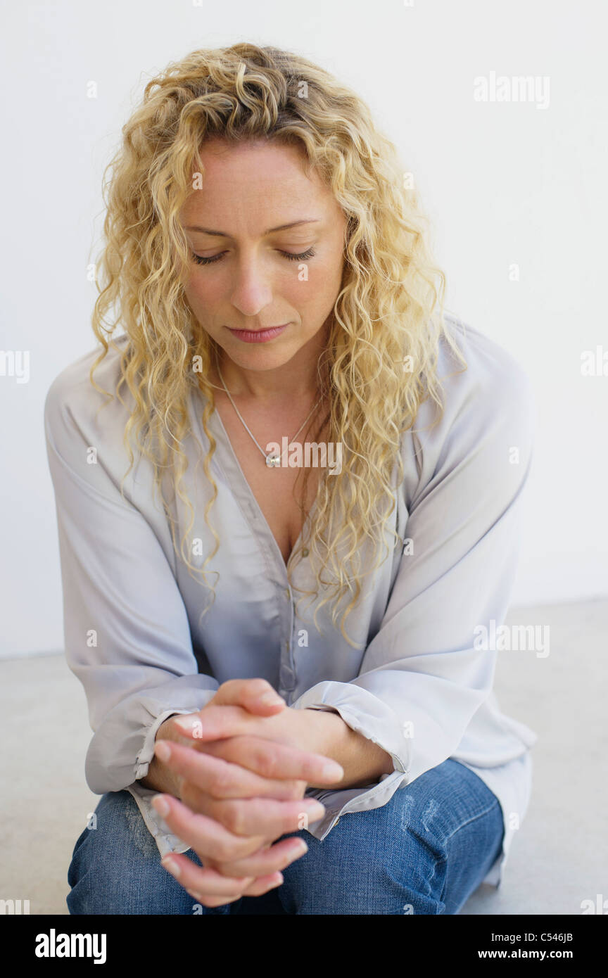 Close-up of a mid adult woman looking sad Stock Photo - Alamy