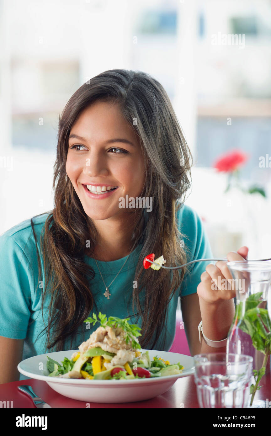 Beautiful woman eating food in a restaurant Stock Photo - Alamy