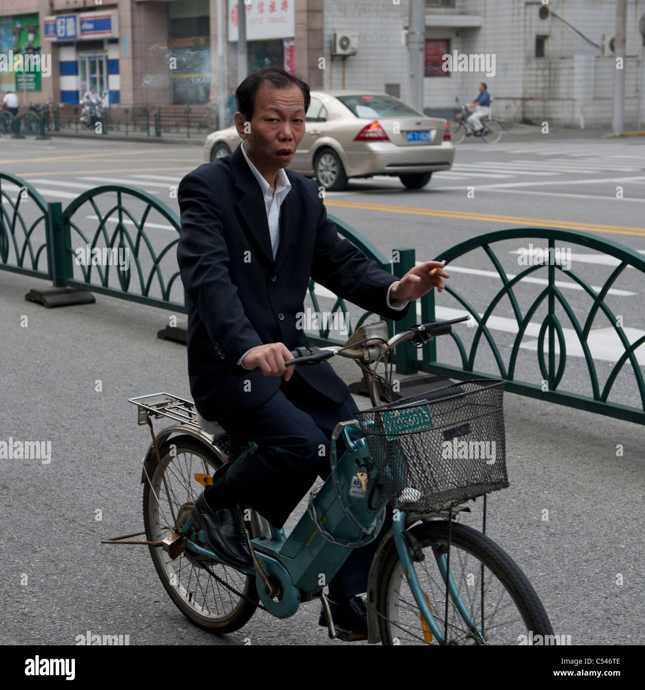 Man riding a bicycle, Shanghai, China Stock Photo - Alamy