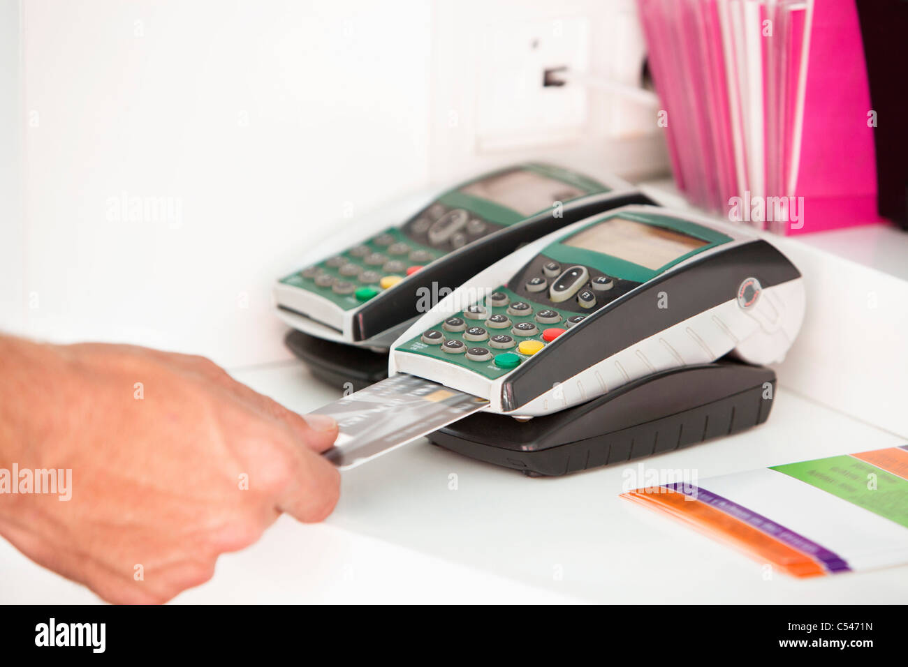 Sales clerk inserting a credit card in a credit card reader Stock Photo ...