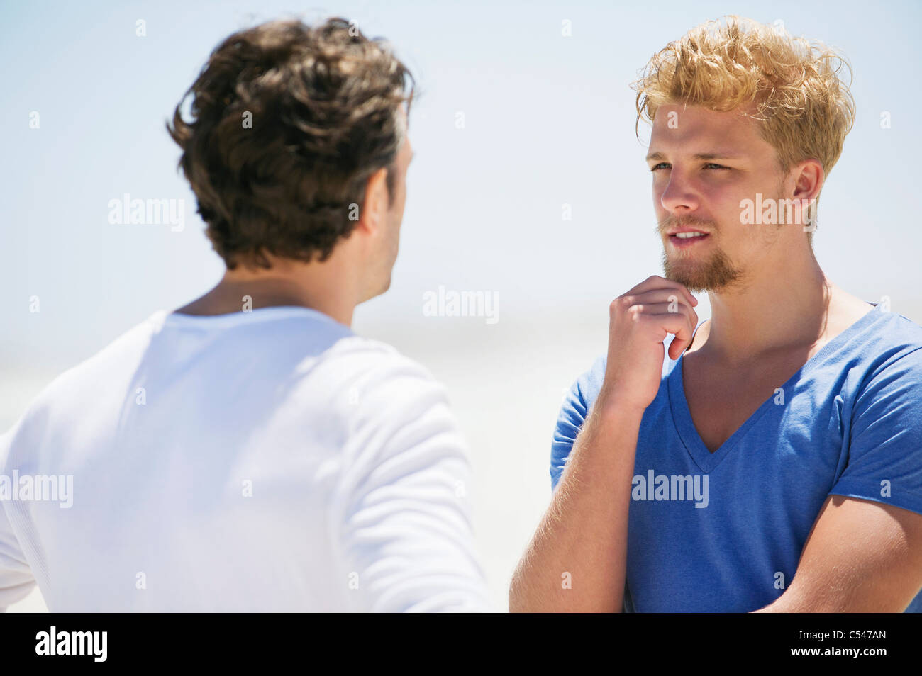 Two men talking to each other Stock Photo - Alamy