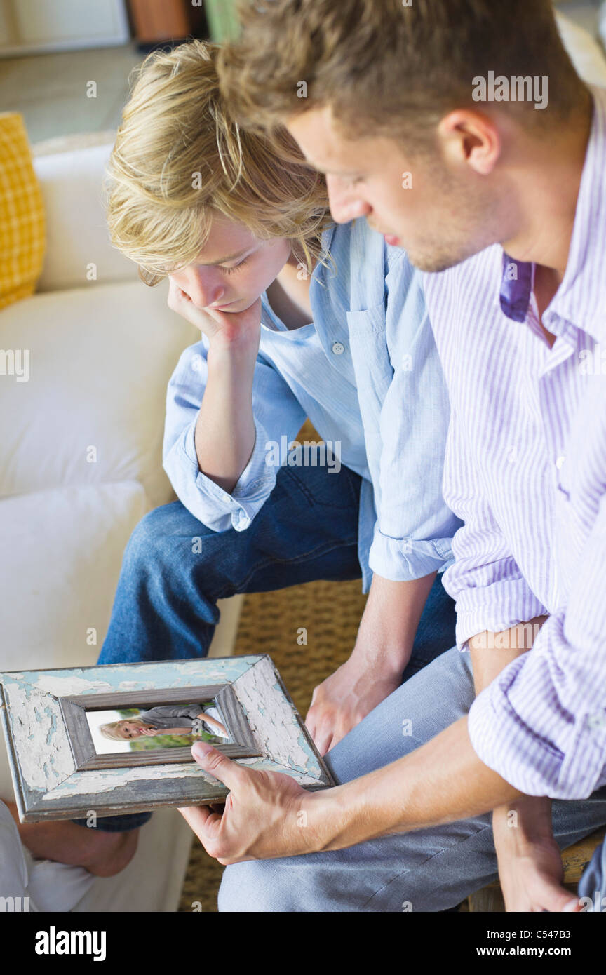 Man and a little boy looking at picture frame Stock Photo - Alamy