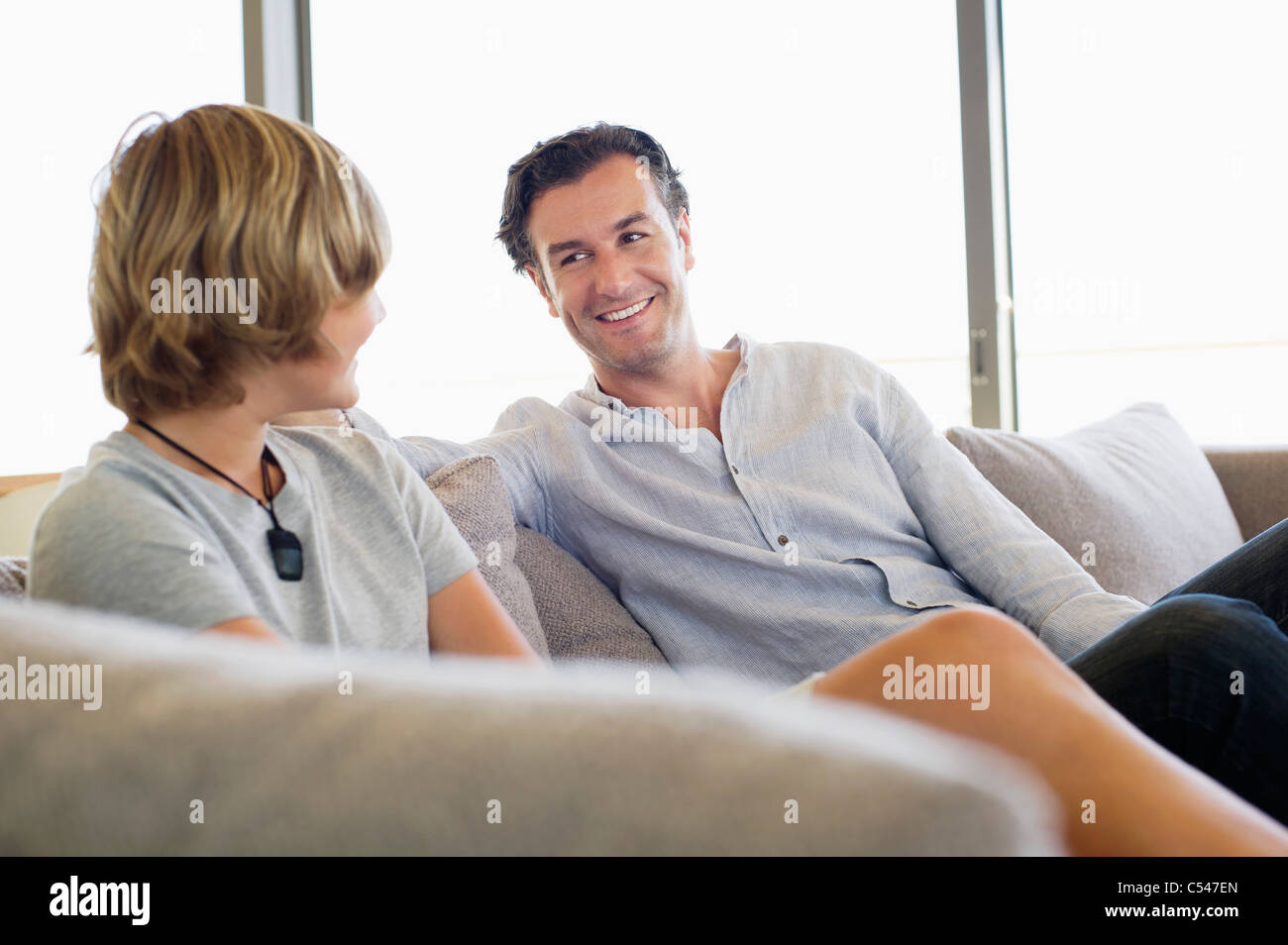 Man talking to his son and smiling Stock Photo - Alamy
