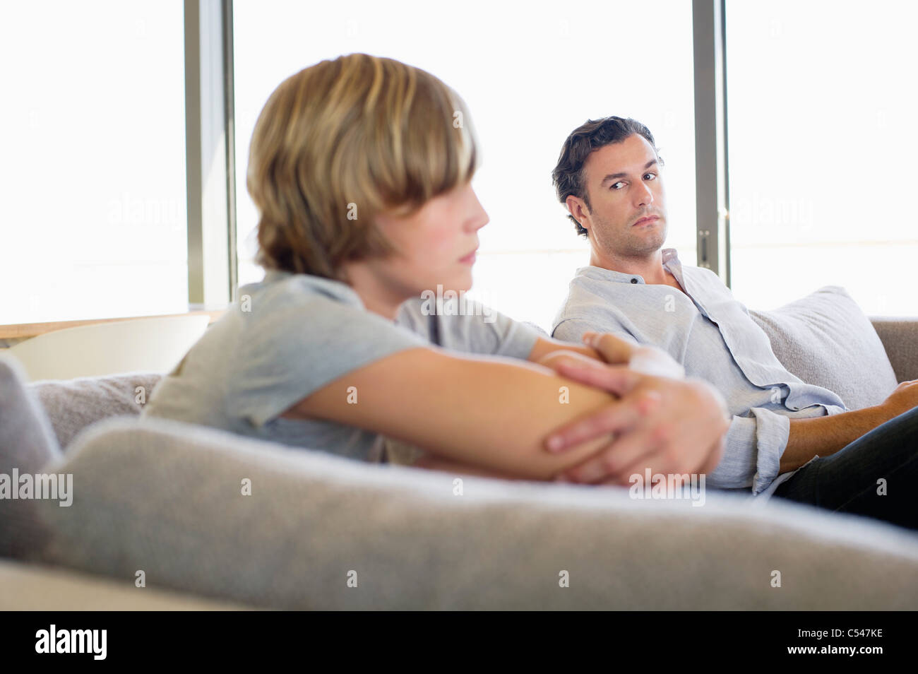 Man looking at his son looking angry Stock Photo - Alamy
