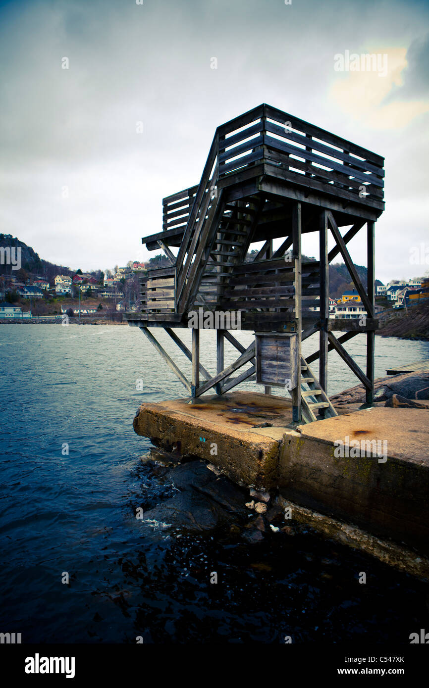 Pier looking over the lake with a small watchtower at the end while a ...