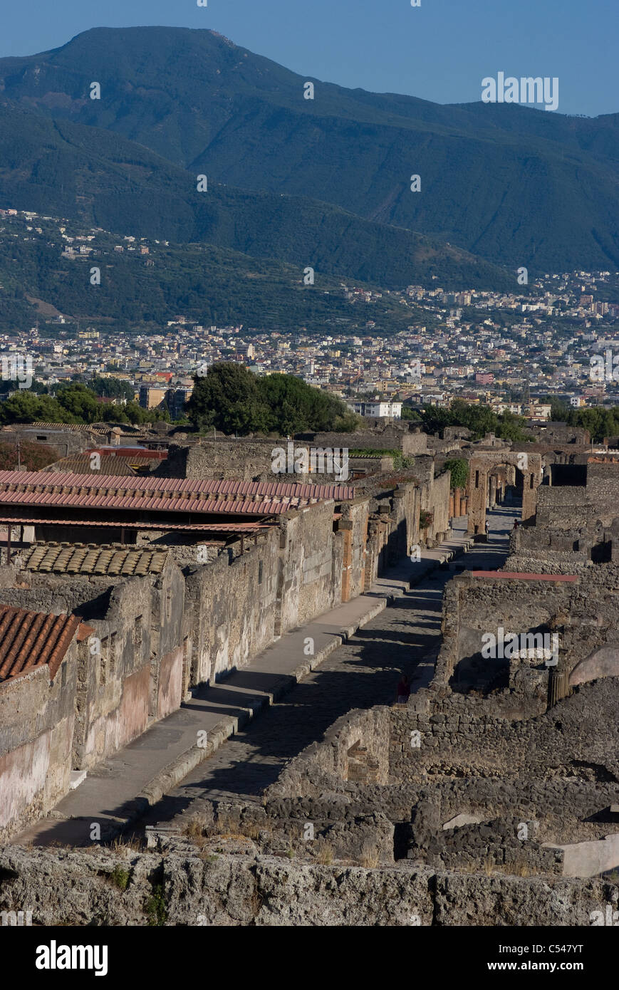 A view overlooking the ruins of the ancient Roman city of Pompeii with ...