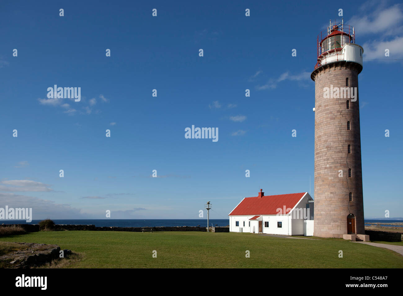 Lighthouse looks over the vast open sea Stock Photo - Alamy