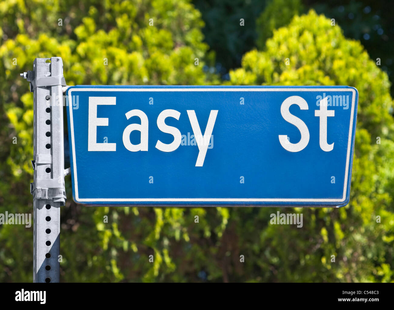 Easy Street sign with bright leafy background Stock Photo - Alamy