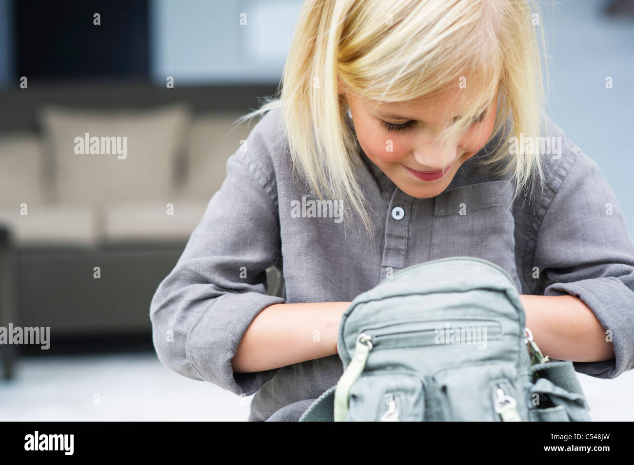 Girl searching in her bag Stock Photo - Alamy