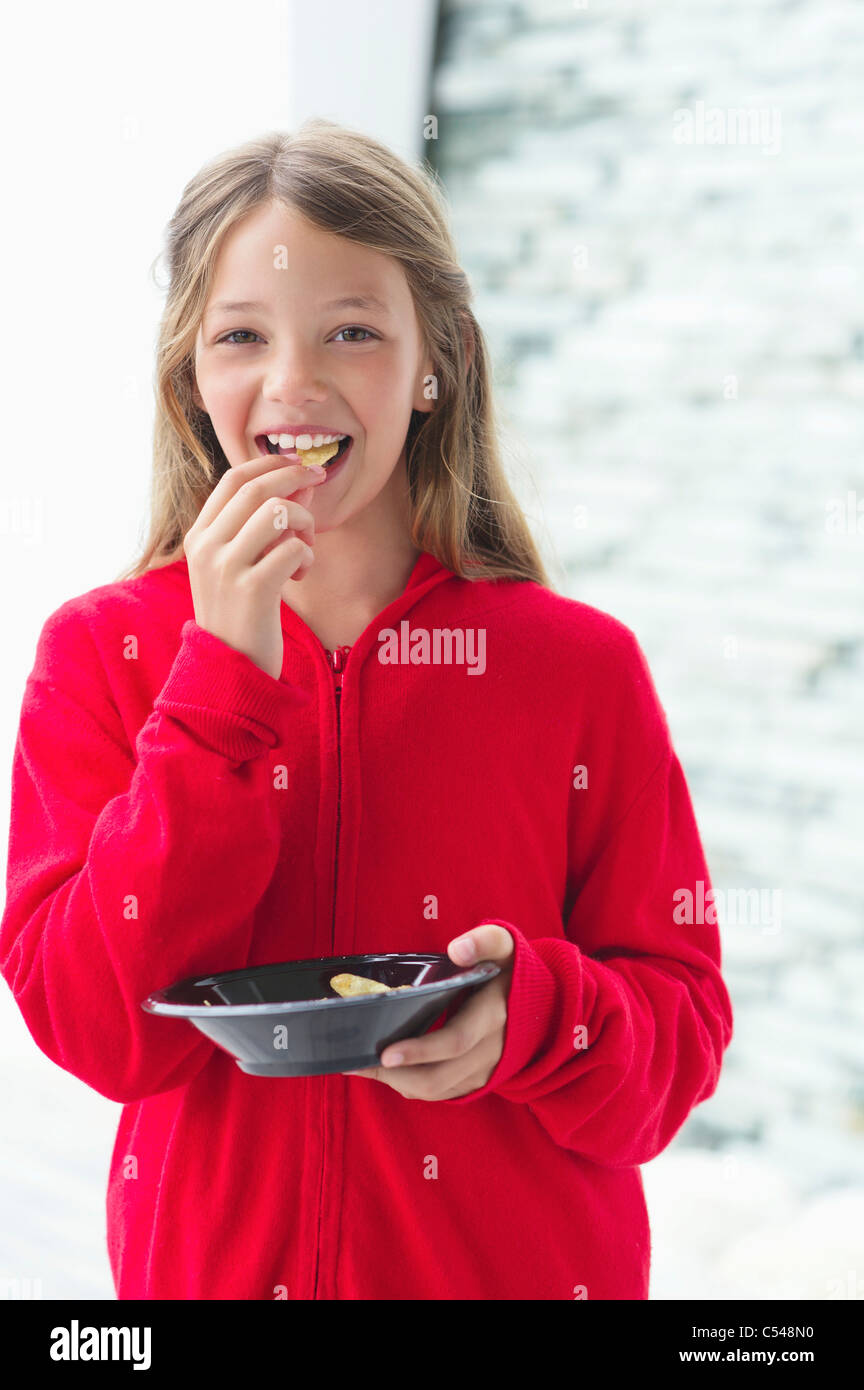 Portrait of a smiling girl eating food Stock Photo - Alamy