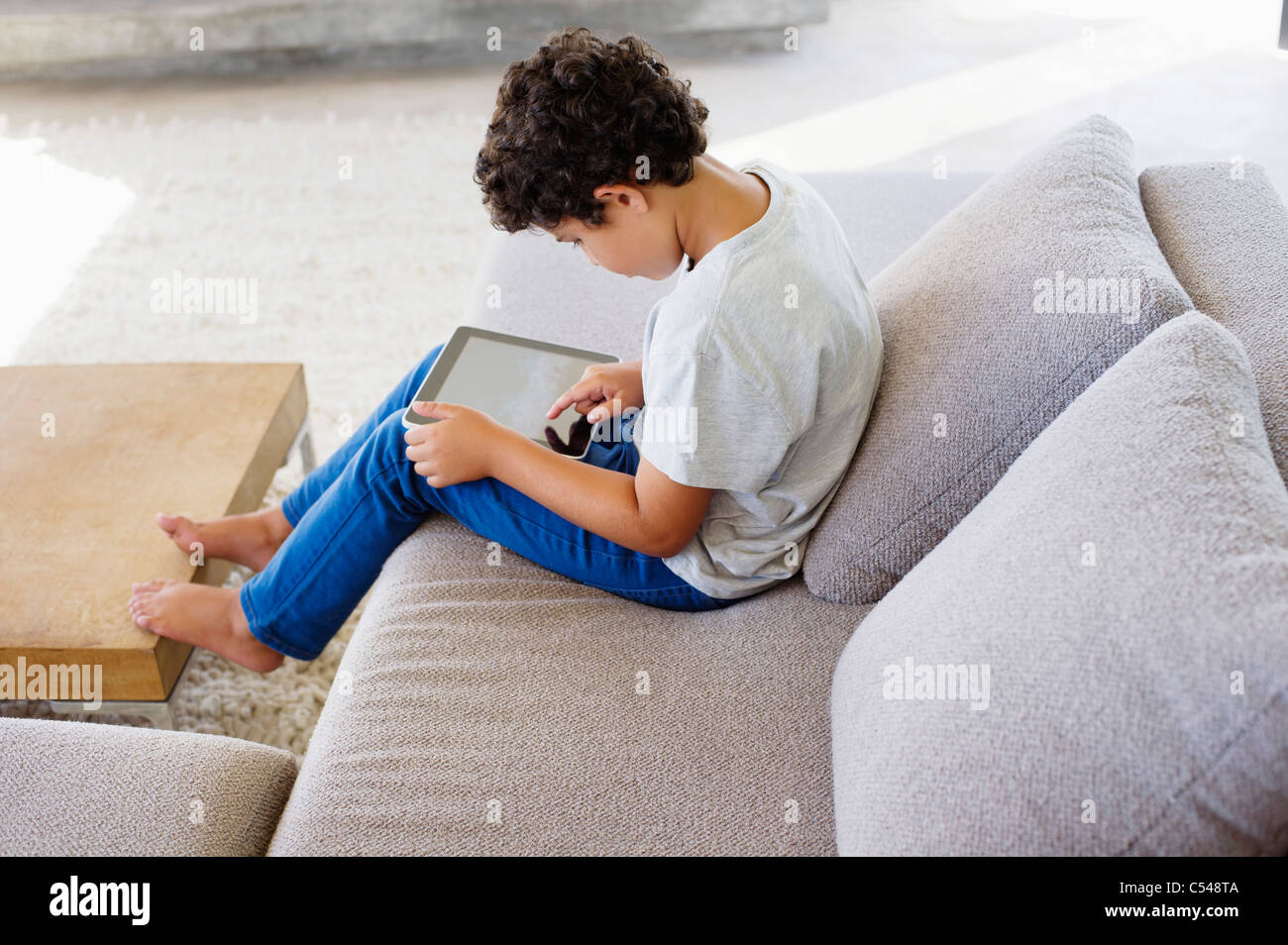 Side profile of a boy using a digital tablet Stock Photo - Alamy