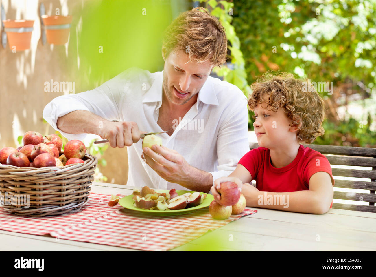 Father peeling apple with son Stock Photo - Alamy