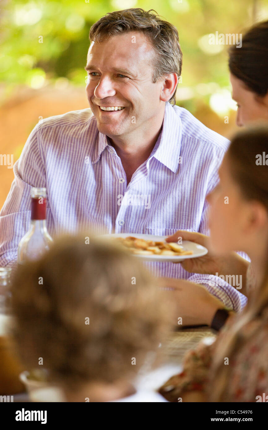 Family having meal and discussing at dining table Stock Photo - Alamy