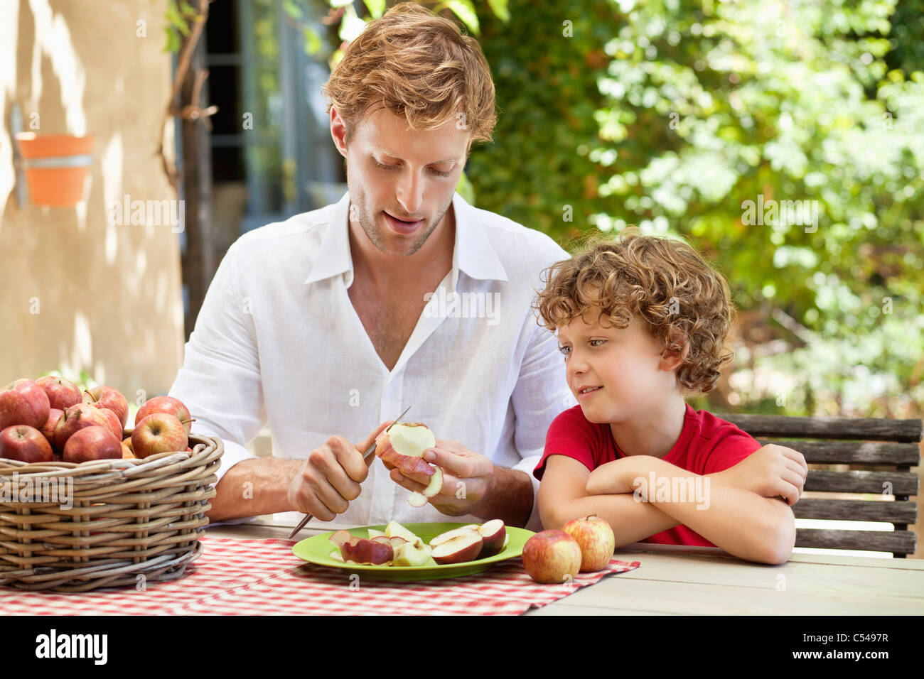Father peeling apple with son Stock Photo - Alamy