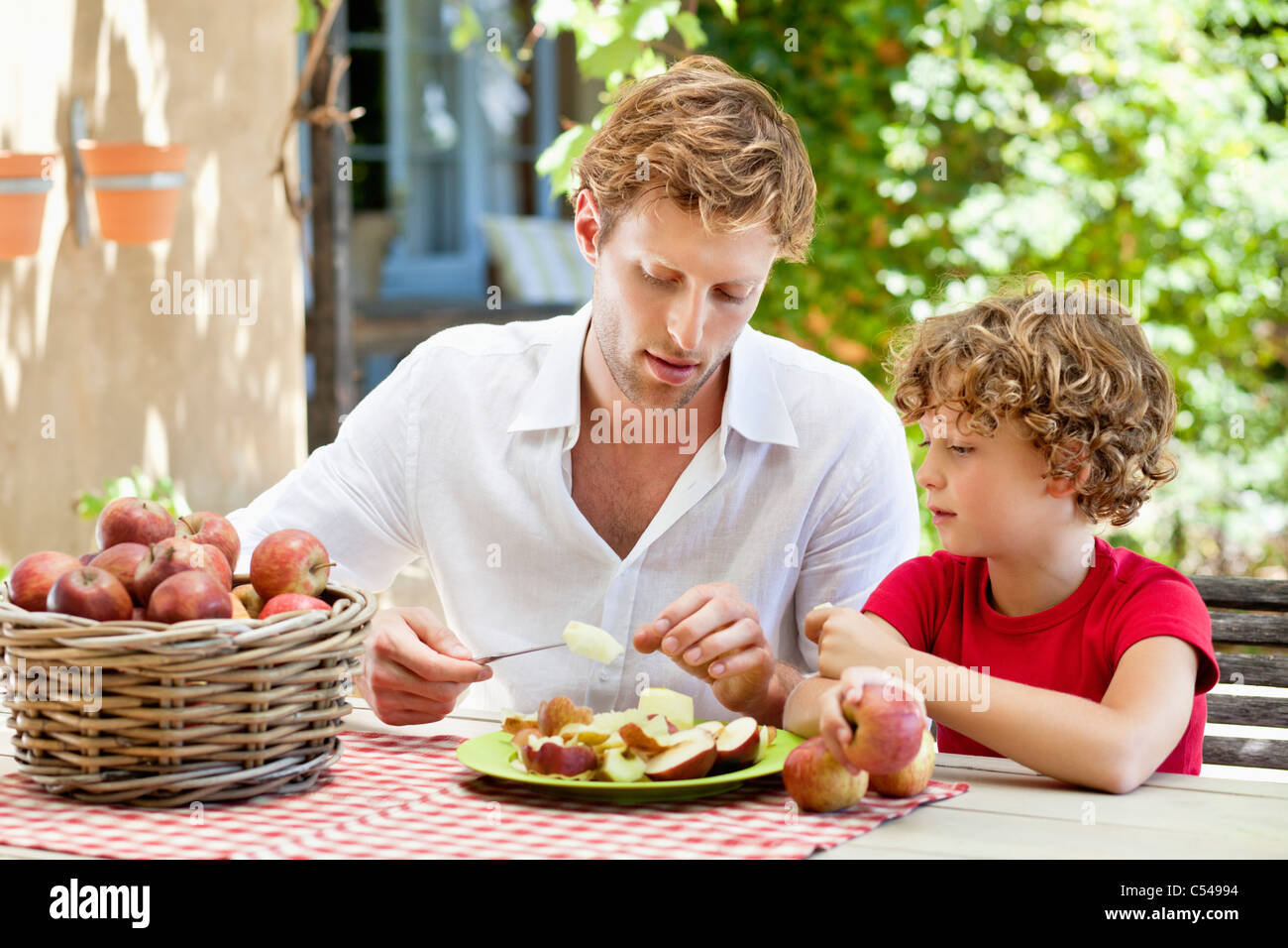 Father peeling apple with son Stock Photo - Alamy