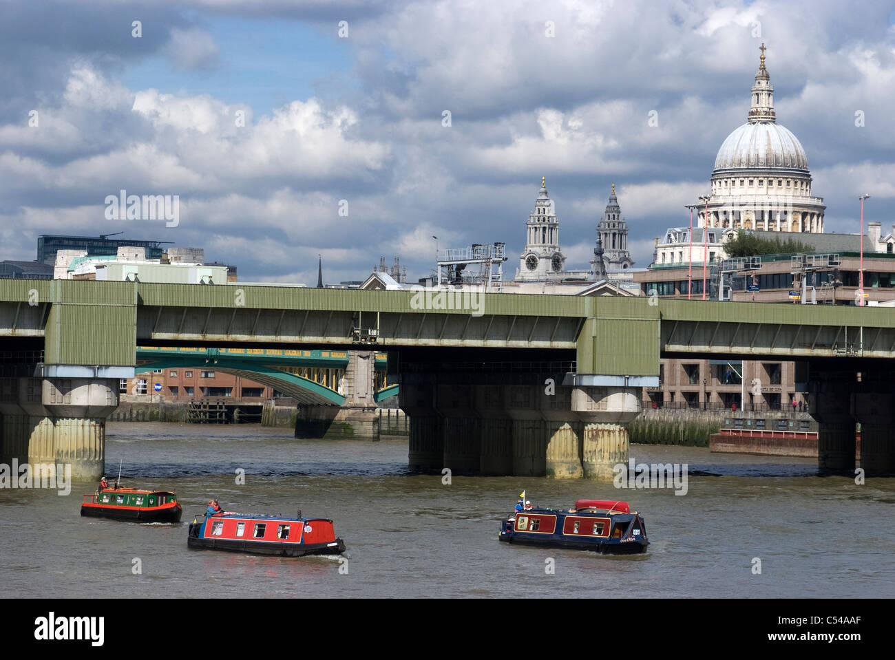 Cannon Street Bridge and narrowboats on the River Thames with St Paul's ...