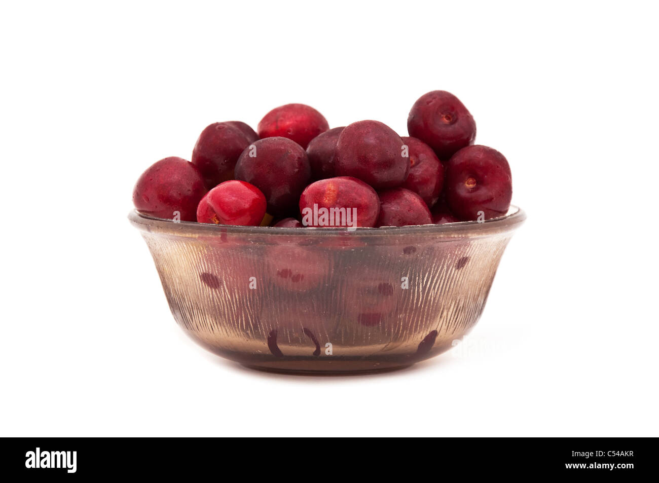 Sweet cherries in a glass pot over a white background Stock Photo - Alamy