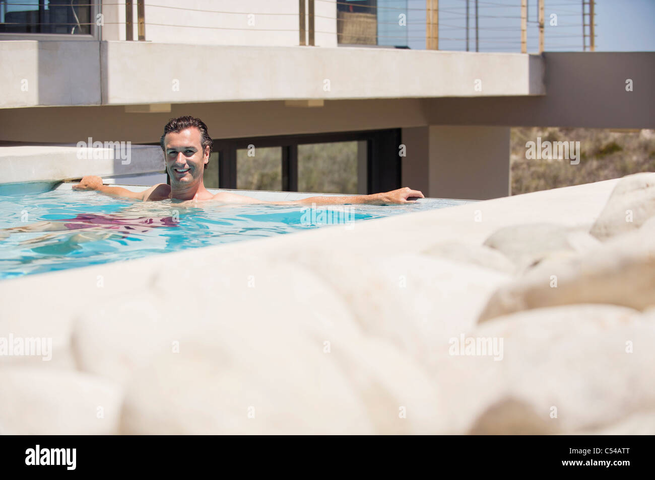 Portrait of a man resting in a swimming pool Stock Photo - Alamy