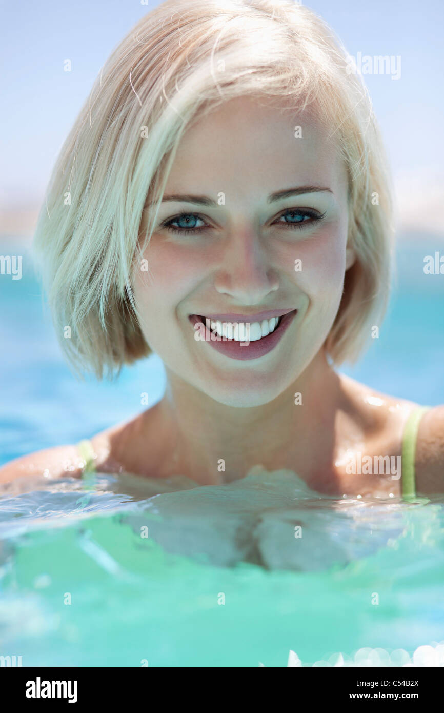 View of beautiful woman smiling in pool Stock Photo - Alamy