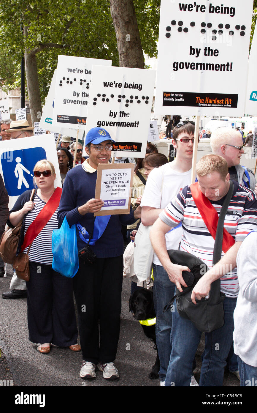 Thousands of disabled people march past Parliament to protest against ...