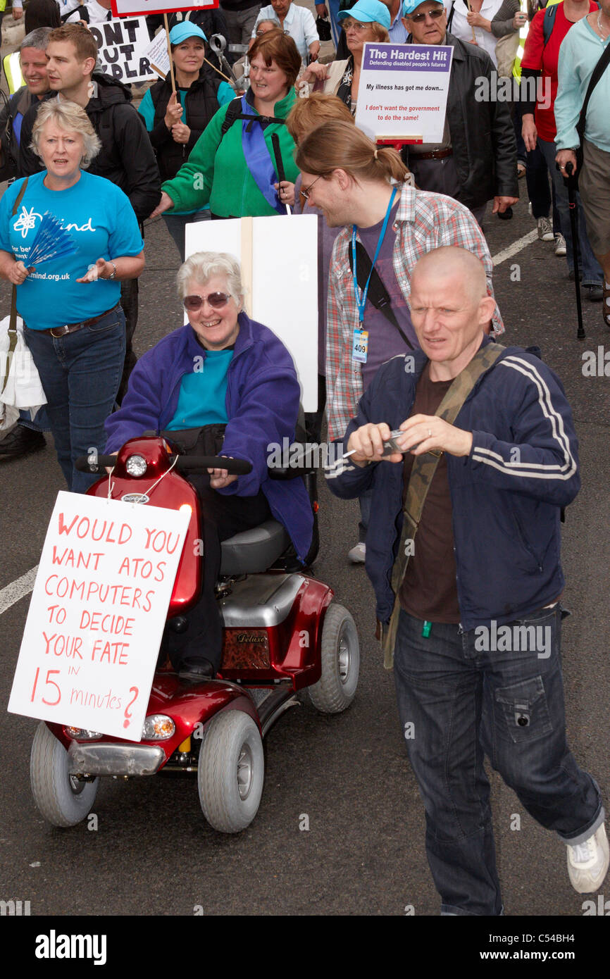Thousands of disabled people march past Parliament to protest against ...