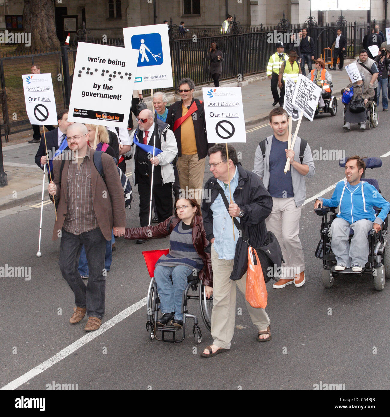 Thousands of disabled people march past Parliament to protest against ...