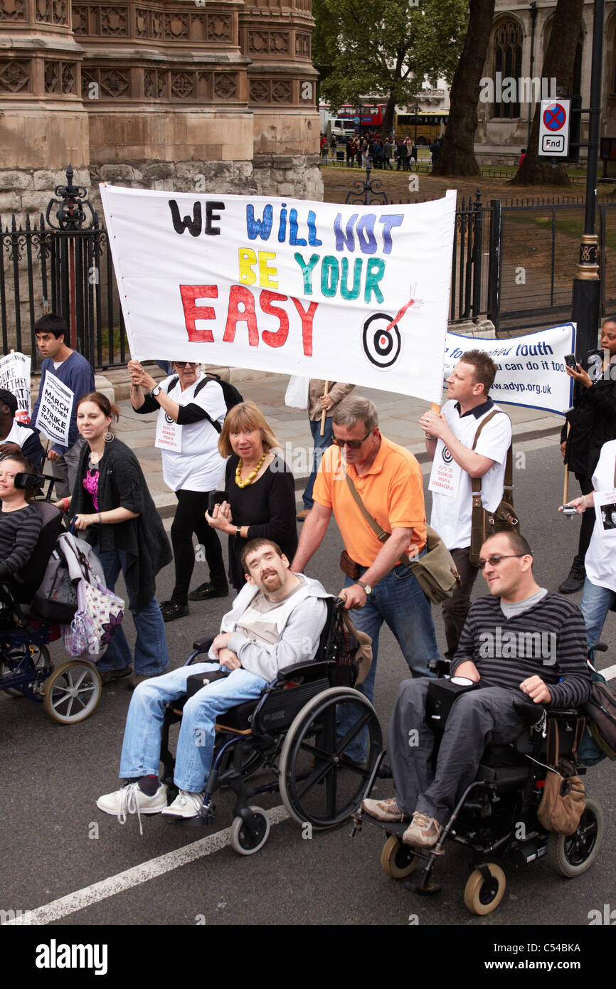 Thousands of disabled people march past Parliament to protest against ...