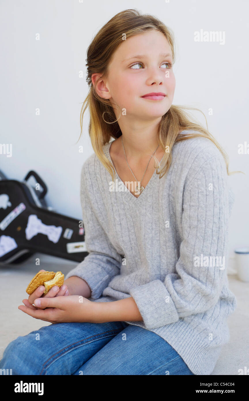 Side profile of a beautiful girl eating cookies Stock Photo - Alamy