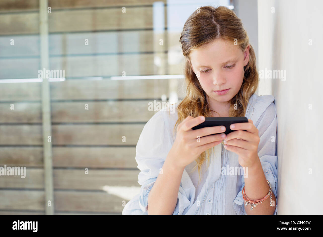 Girl playing handheld video game hi-res stock photography and images ...