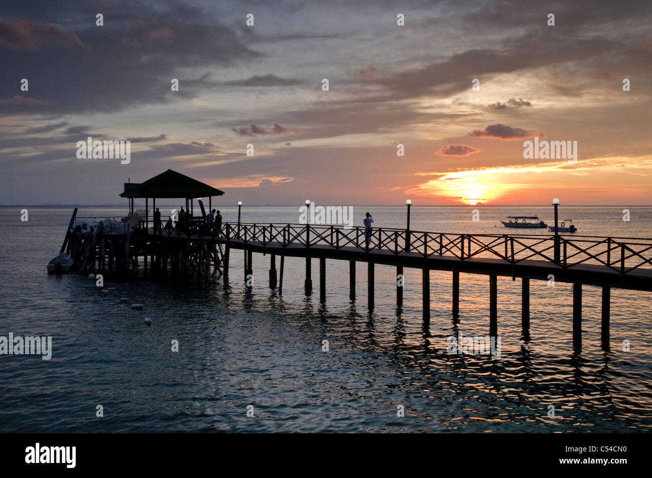 Pier of the Panuba Inn Resort at sunset on the beach of Panuba, Pulau ...