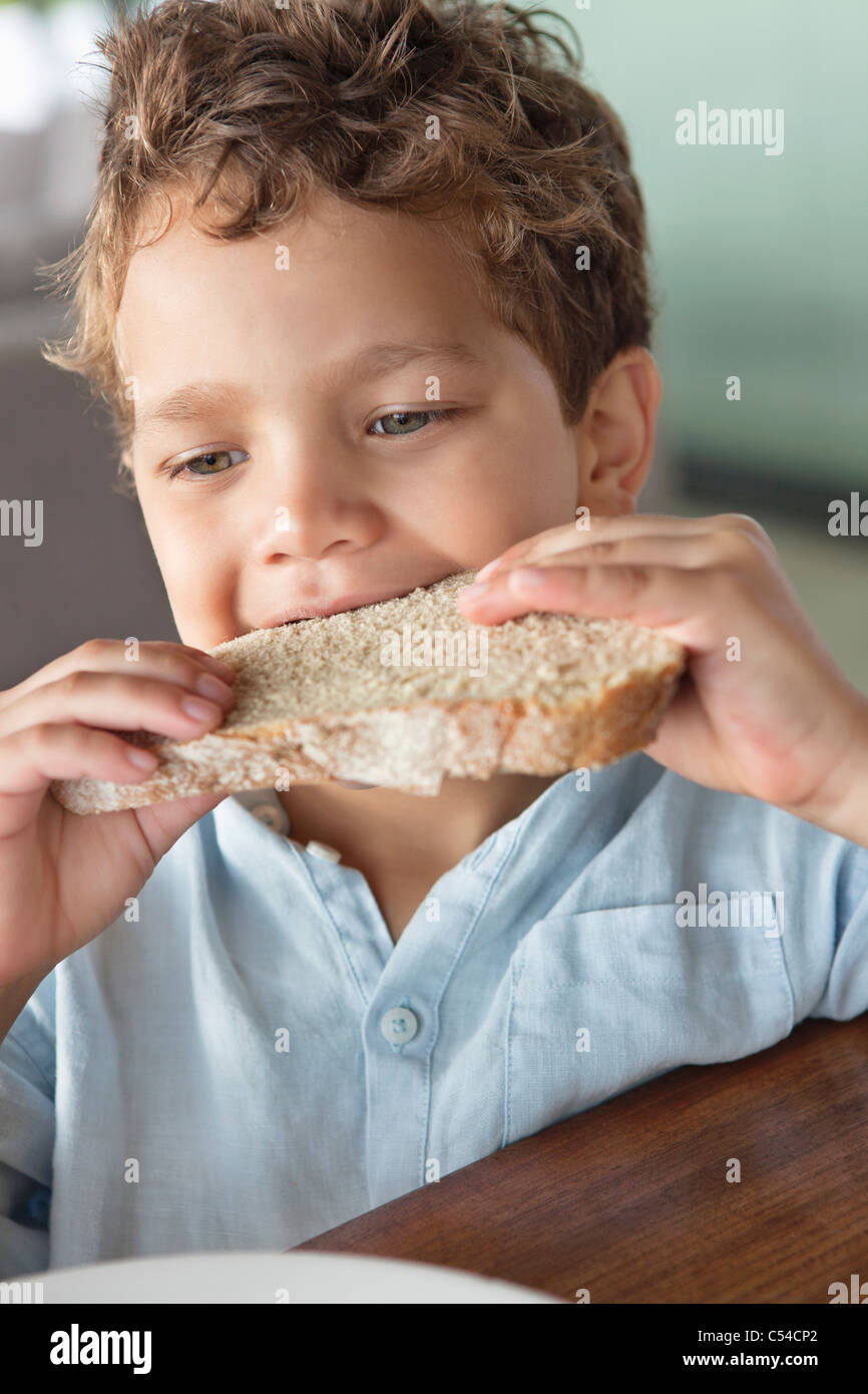 Close-up of a boy eating bread Stock Photo - Alamy