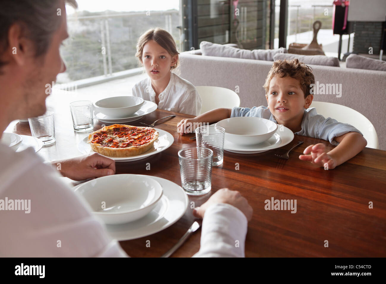 Two girls man talking table hi-res stock photography and images - Alamy
