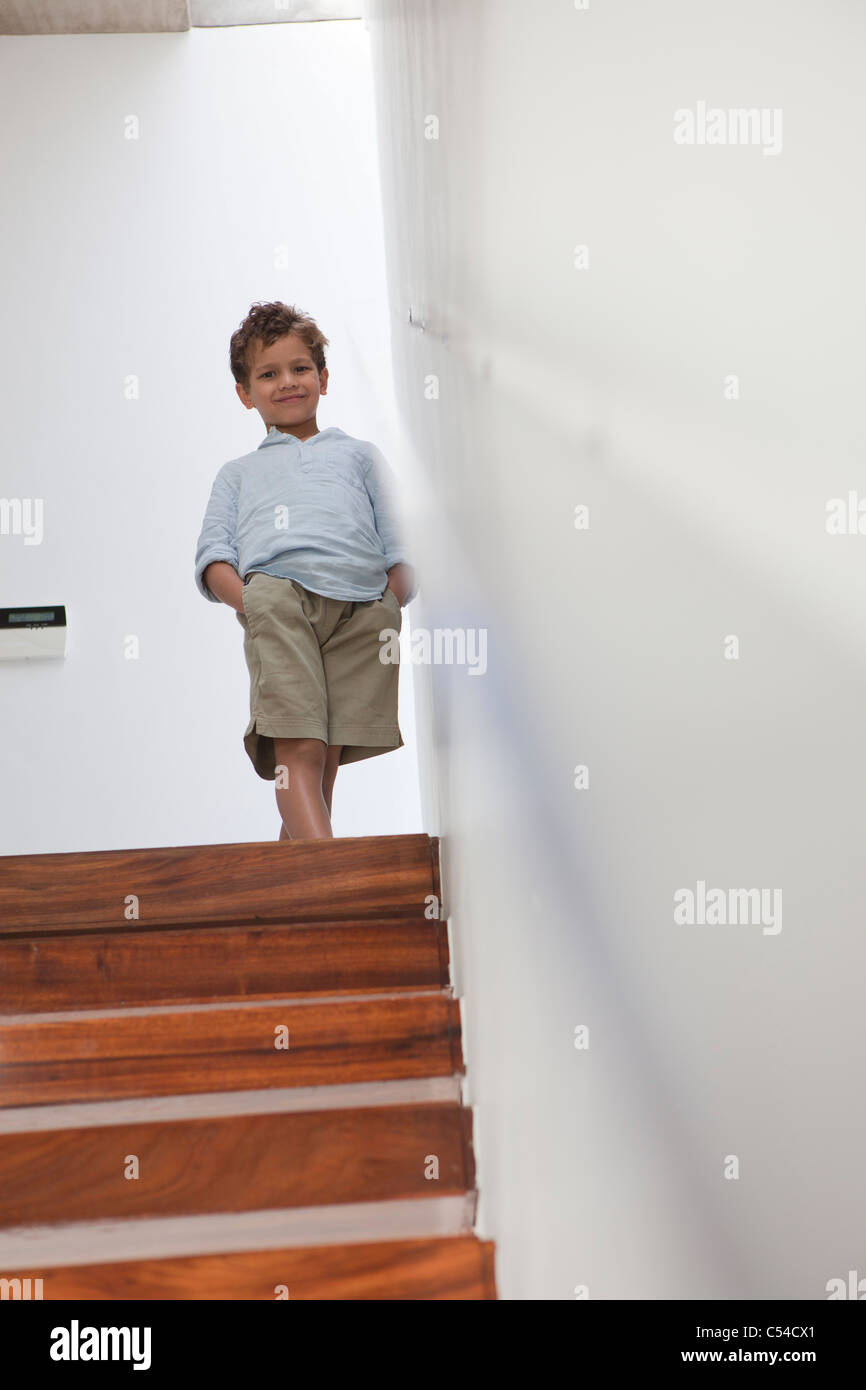 Boy standing on a staircase Stock Photo - Alamy