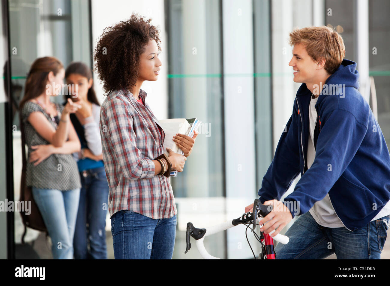 Two friends discussing in campus Stock Photo - Alamy