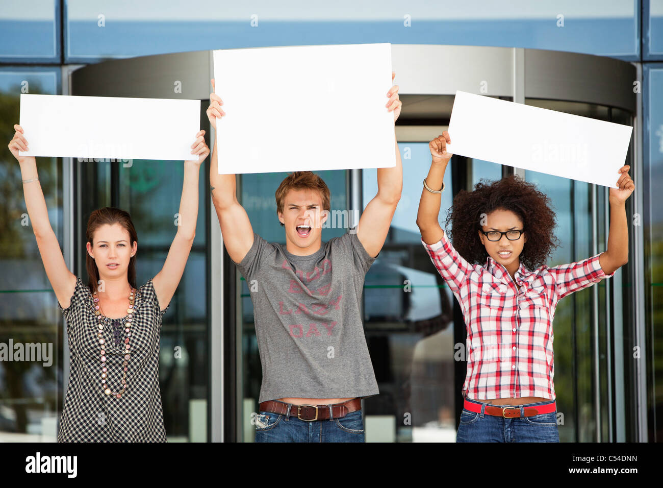 Angry friends protesting with blank placards Stock Photo - Alamy