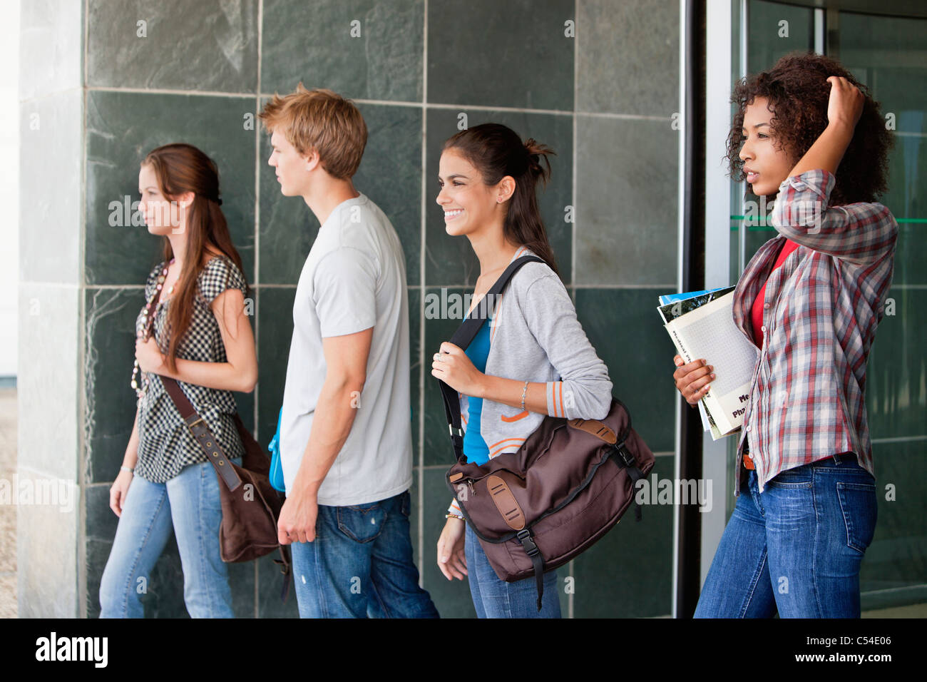 Smiling university students walking in campus Stock Photo - Alamy