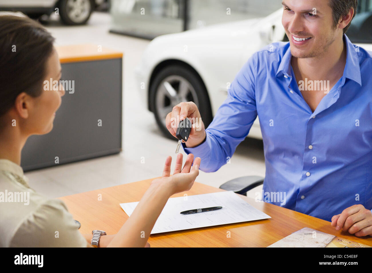 Man handing a paper to a woman hi-res stock photography and images - Alamy