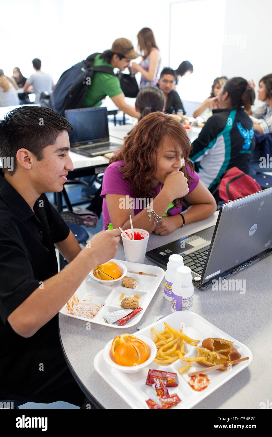 High school students use laptop computers during lunch at school in El ...