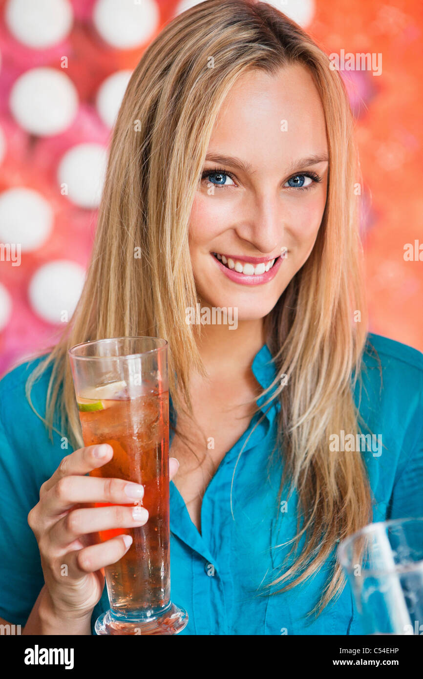 Portrait of a beautiful woman having ice tea in a bar and smiling Stock ...