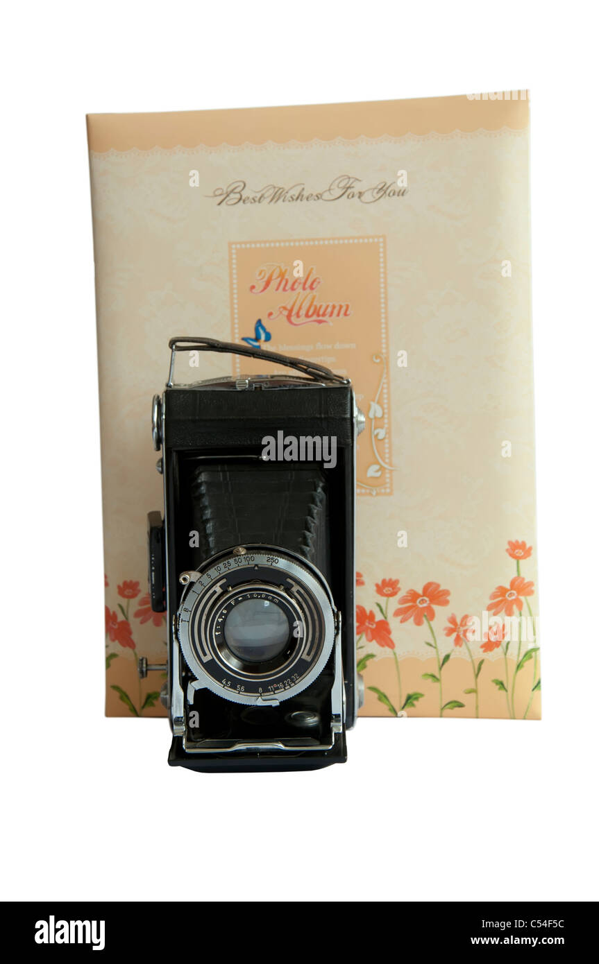 Photo album and vintage camera isolated on white Stock Photo - Alamy