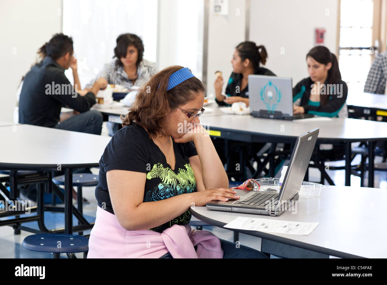 Hispanic students use laptop computers during lunch at Mission Early ...