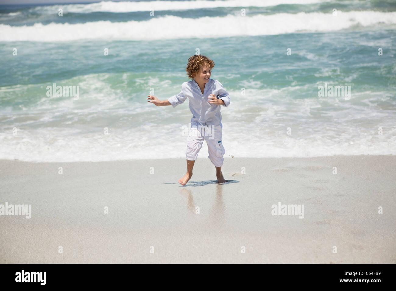 Boy playing on beach Stock Photo - Alamy